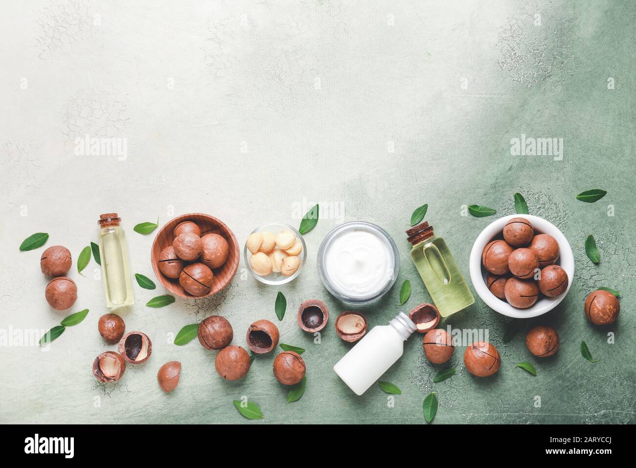 Macadamia nuts with cosmetics on color background Stock Photo - Alamy