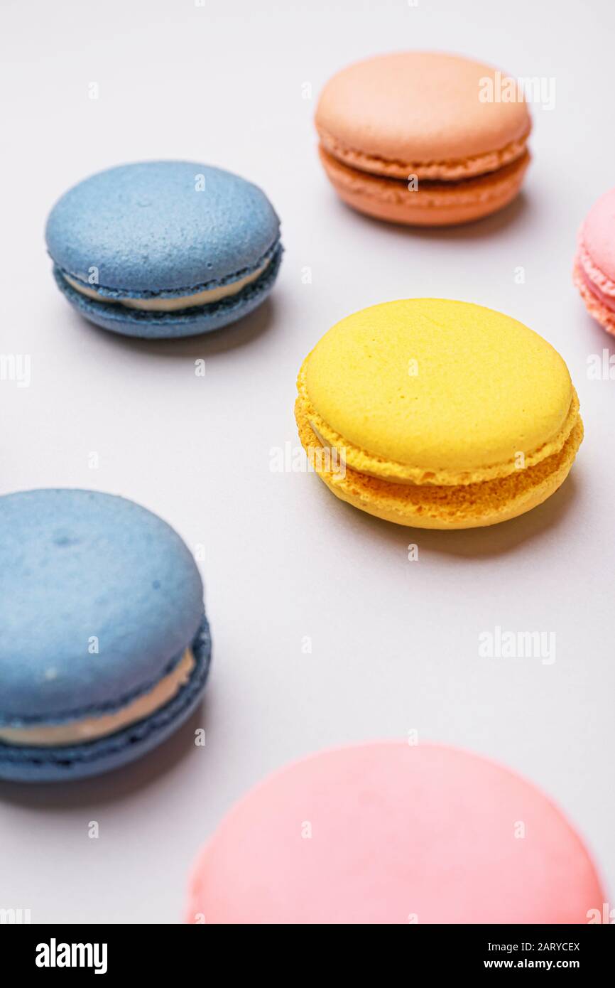 Different tasty macarons on light background Stock Photo - Alamy