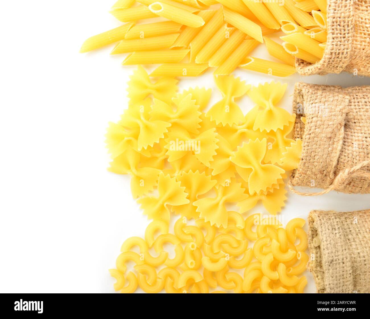Bags with different uncooked pasta on white background Stock Photo - Alamy
