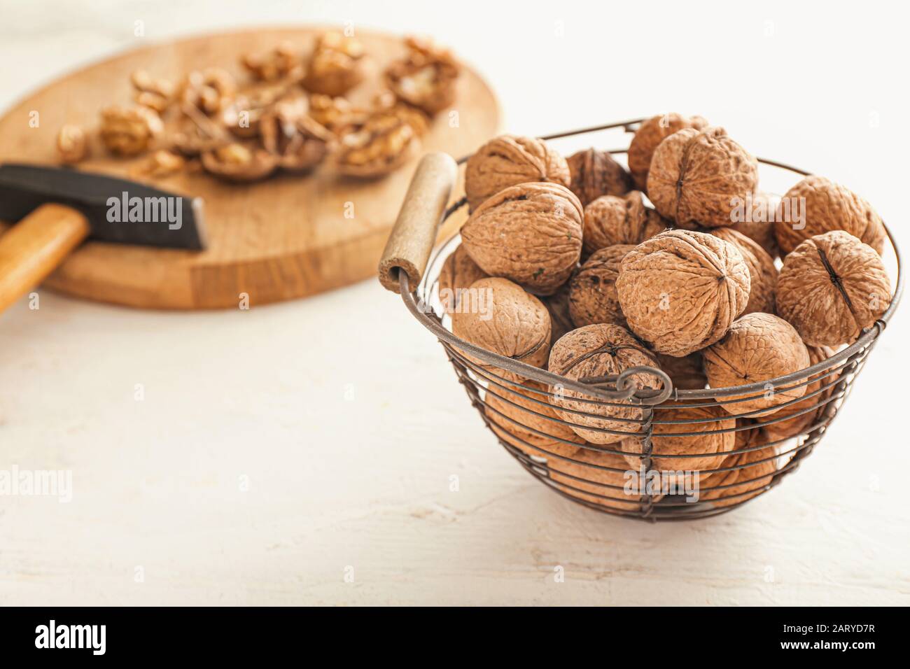 Basket with tasty walnuts on white background Stock Photo - Alamy