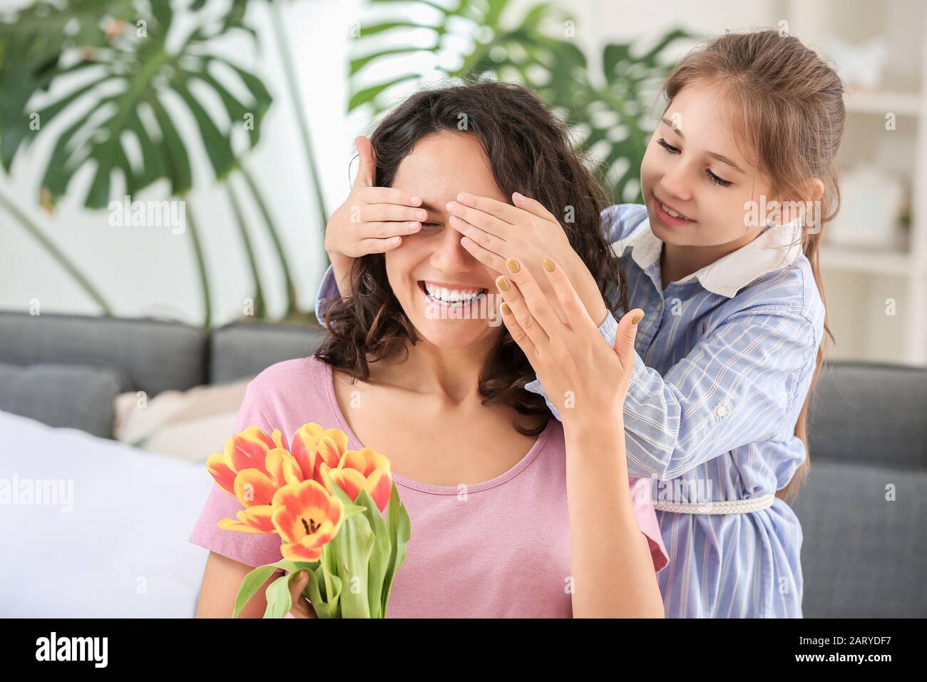 Little girl greeting her mother at home Stock Photo - Alamy