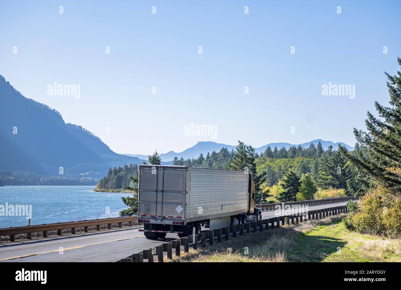 Classic dark big rig heavy-duty long haul diesel semi truck with ...