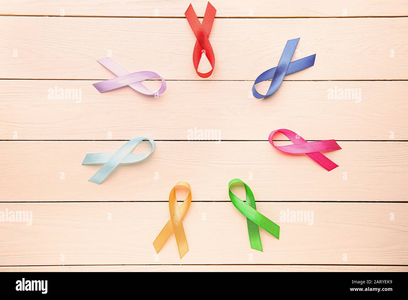 Different awareness ribbons on white wooden background Stock Photo - Alamy