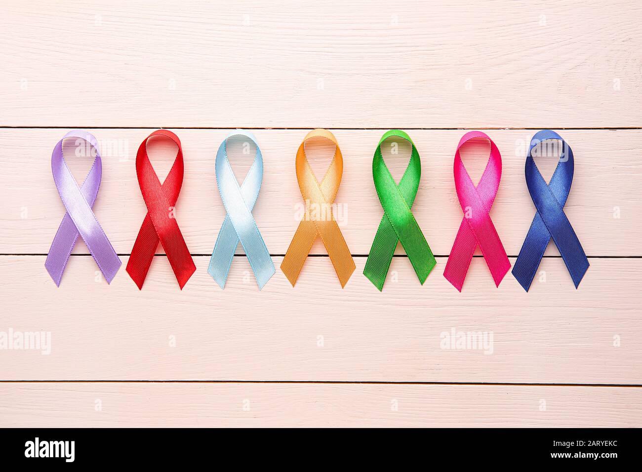 Different awareness ribbons on white wooden background Stock Photo - Alamy