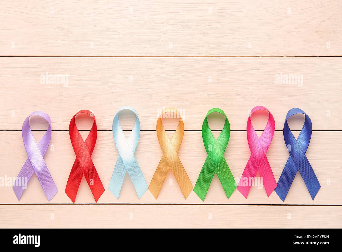 Different awareness ribbons on white wooden background Stock Photo - Alamy
