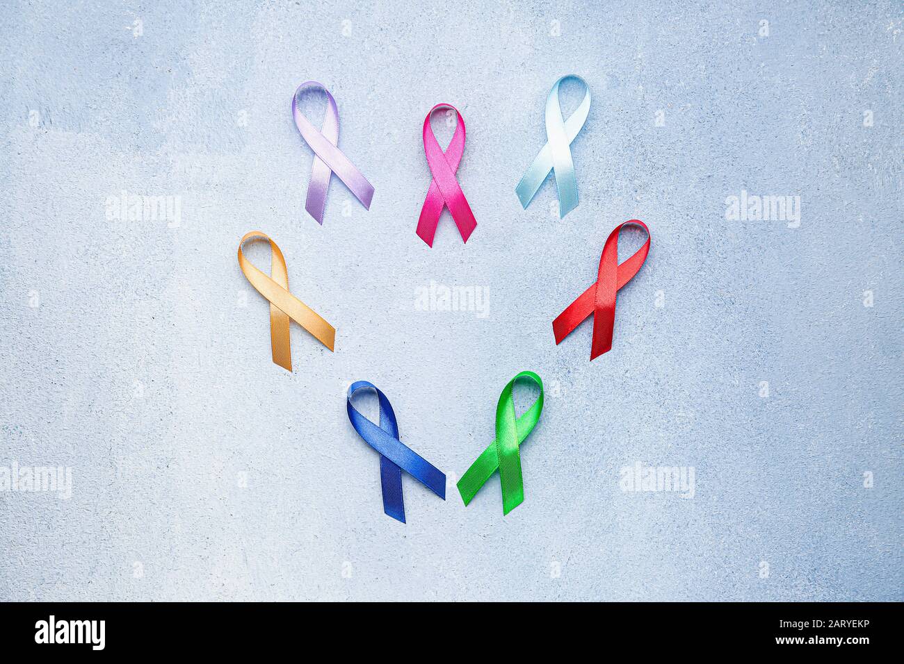 Different awareness ribbons on color background Stock Photo - Alamy