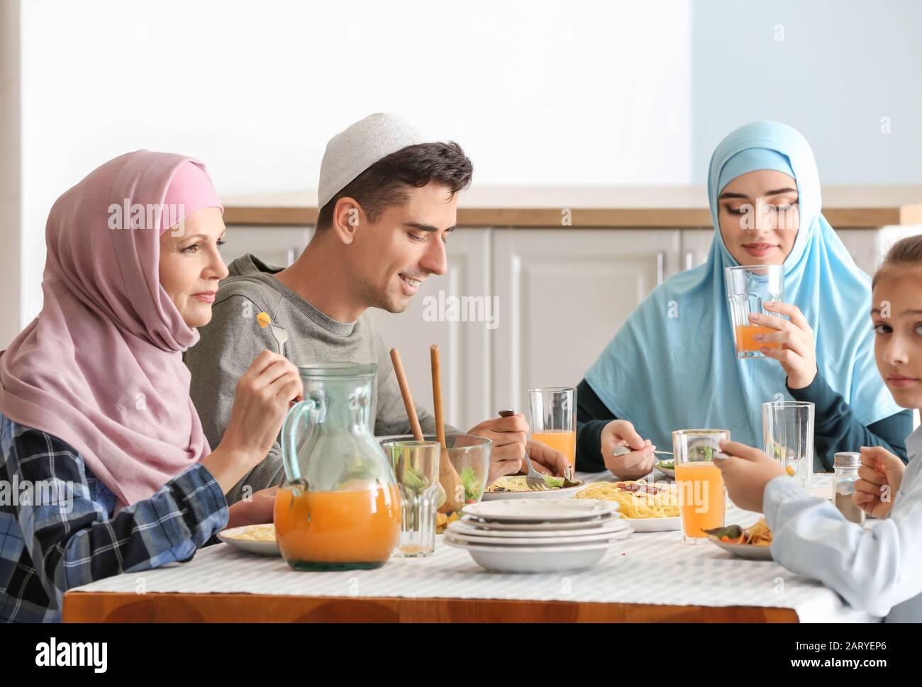 Muslim family having dinner at home Stock Photo - Alamy