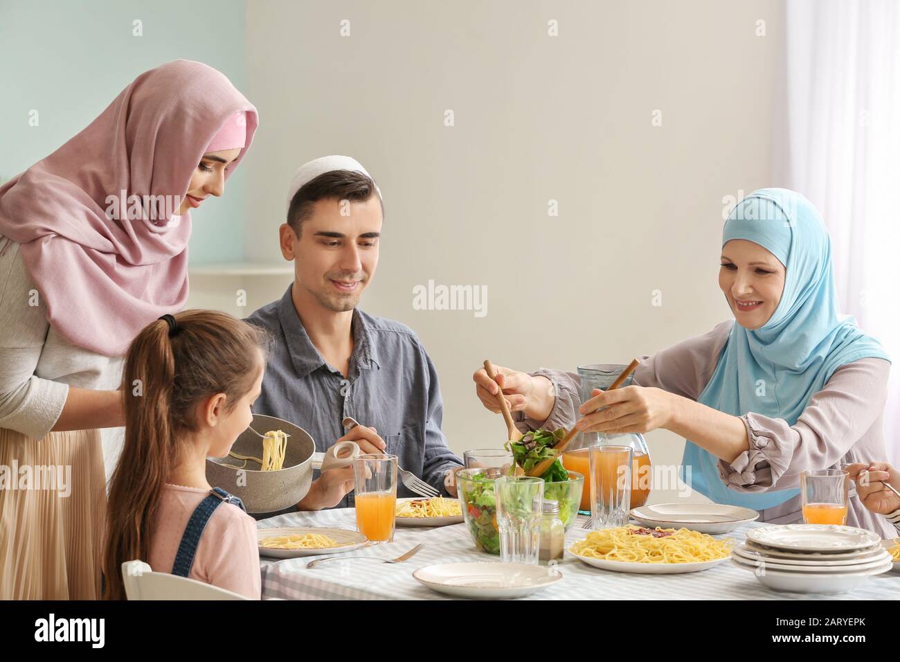 Muslim family having dinner at home Stock Photo - Alamy