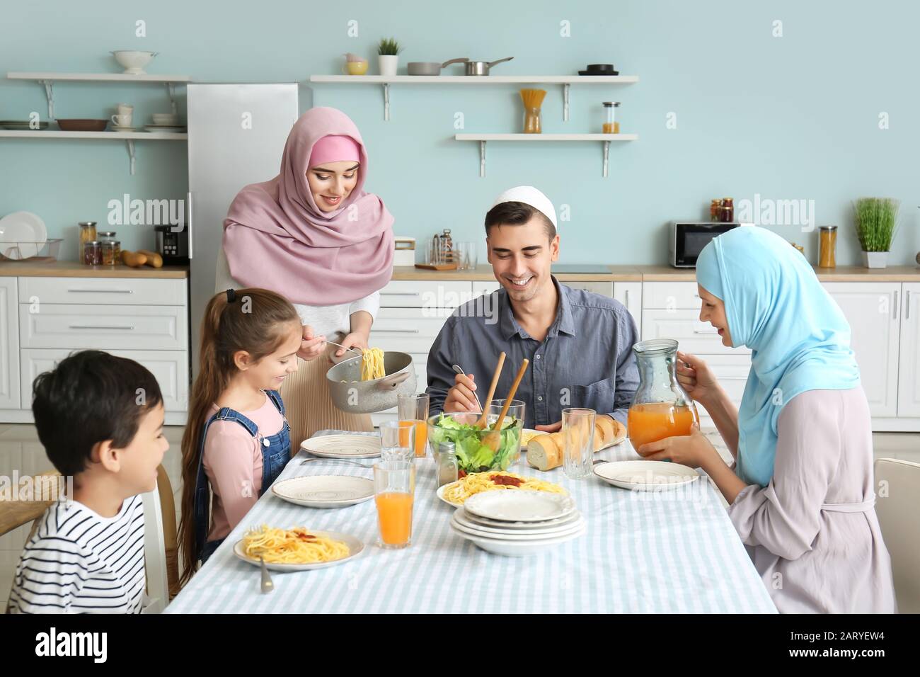 Muslim family having dinner at home Stock Photo - Alamy