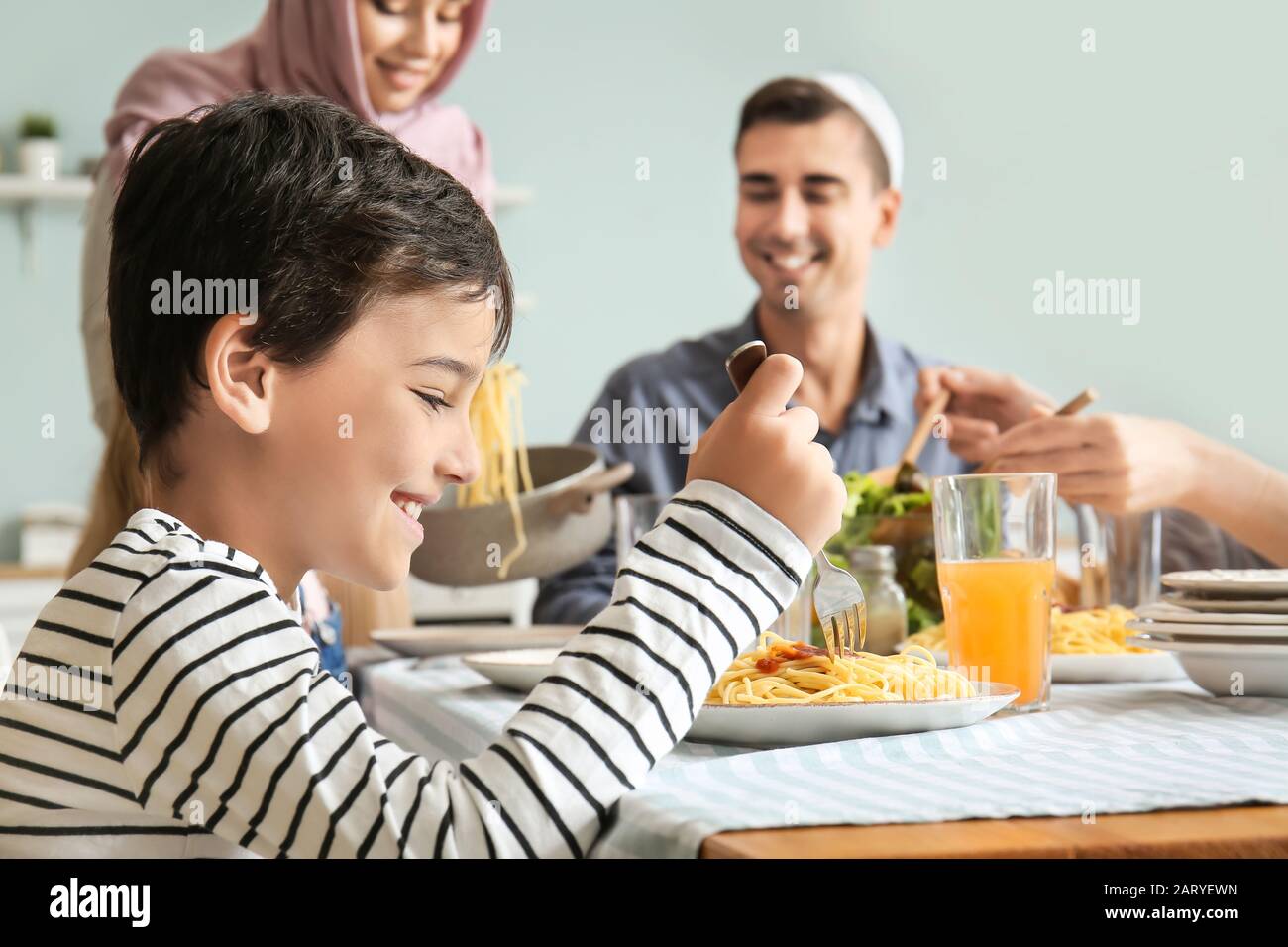Muslim family having dinner at home Stock Photo - Alamy