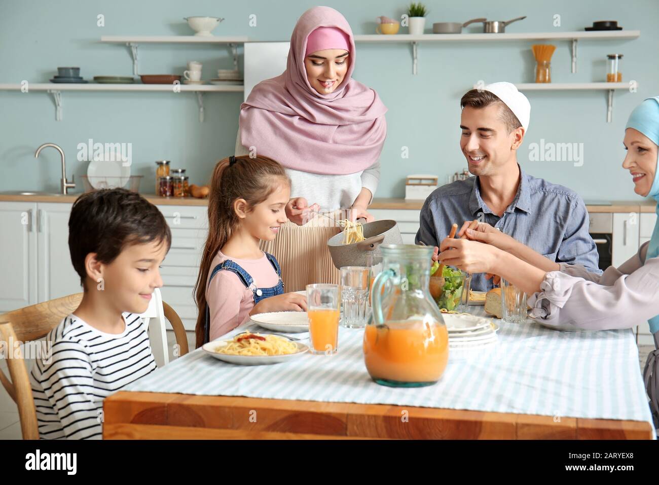 Muslim family having dinner at home Stock Photo - Alamy