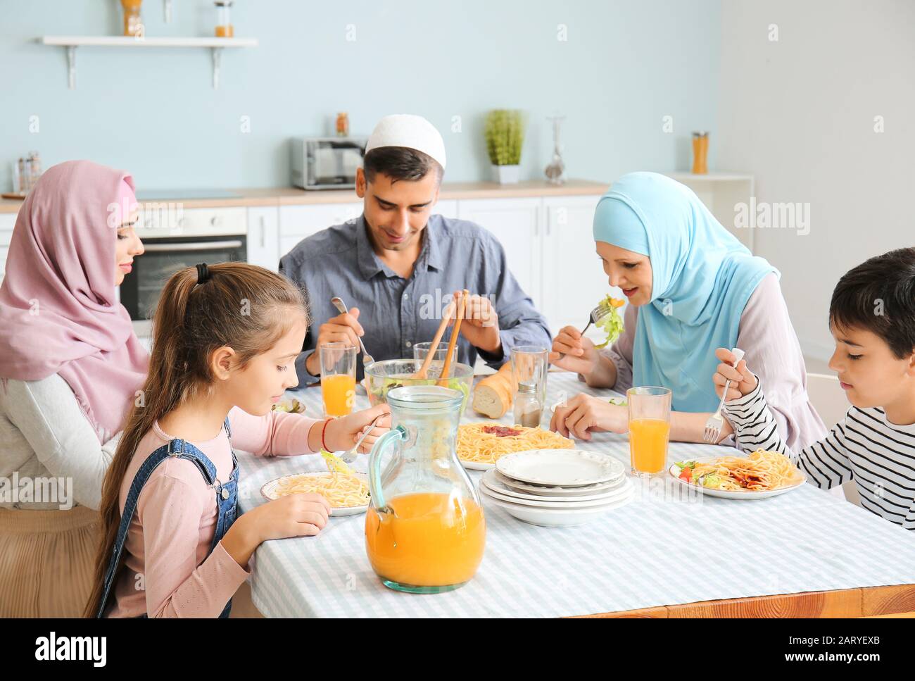 Muslim family having dinner at home Stock Photo - Alamy