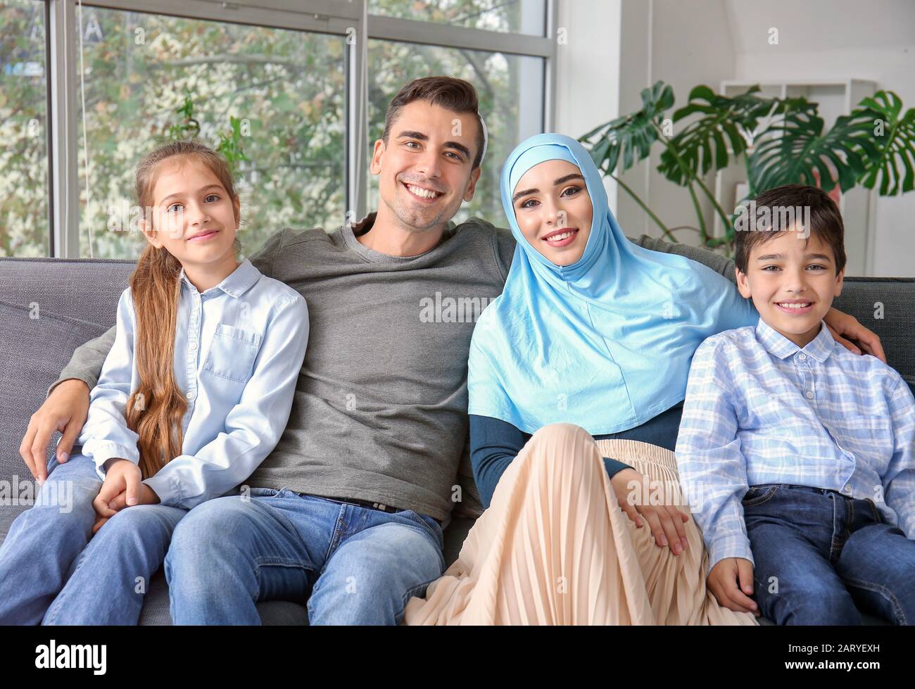 Portrait of happy Muslim family at home Stock Photo - Alamy