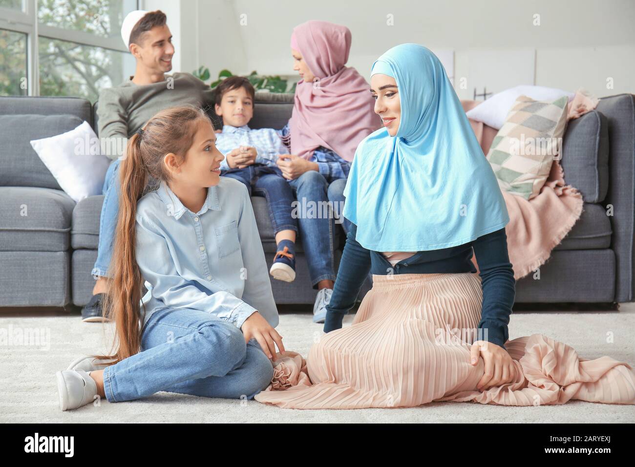 Portrait of happy Muslim family at home Stock Photo - Alamy