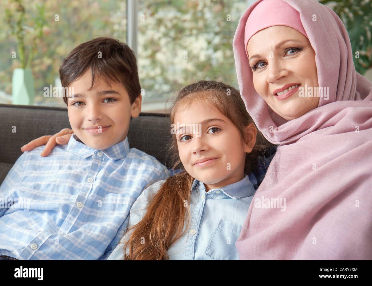 Portrait of happy Muslim family at home Stock Photo - Alamy