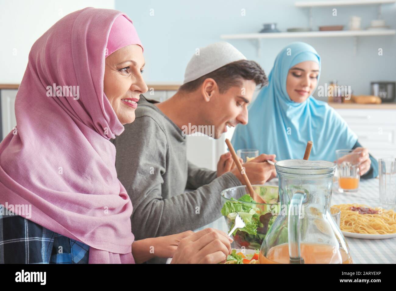 Muslim family having dinner at home Stock Photo - Alamy