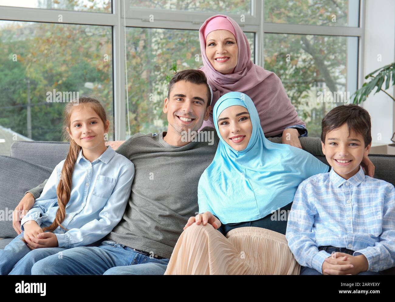 Portrait of happy Muslim family at home Stock Photo - Alamy