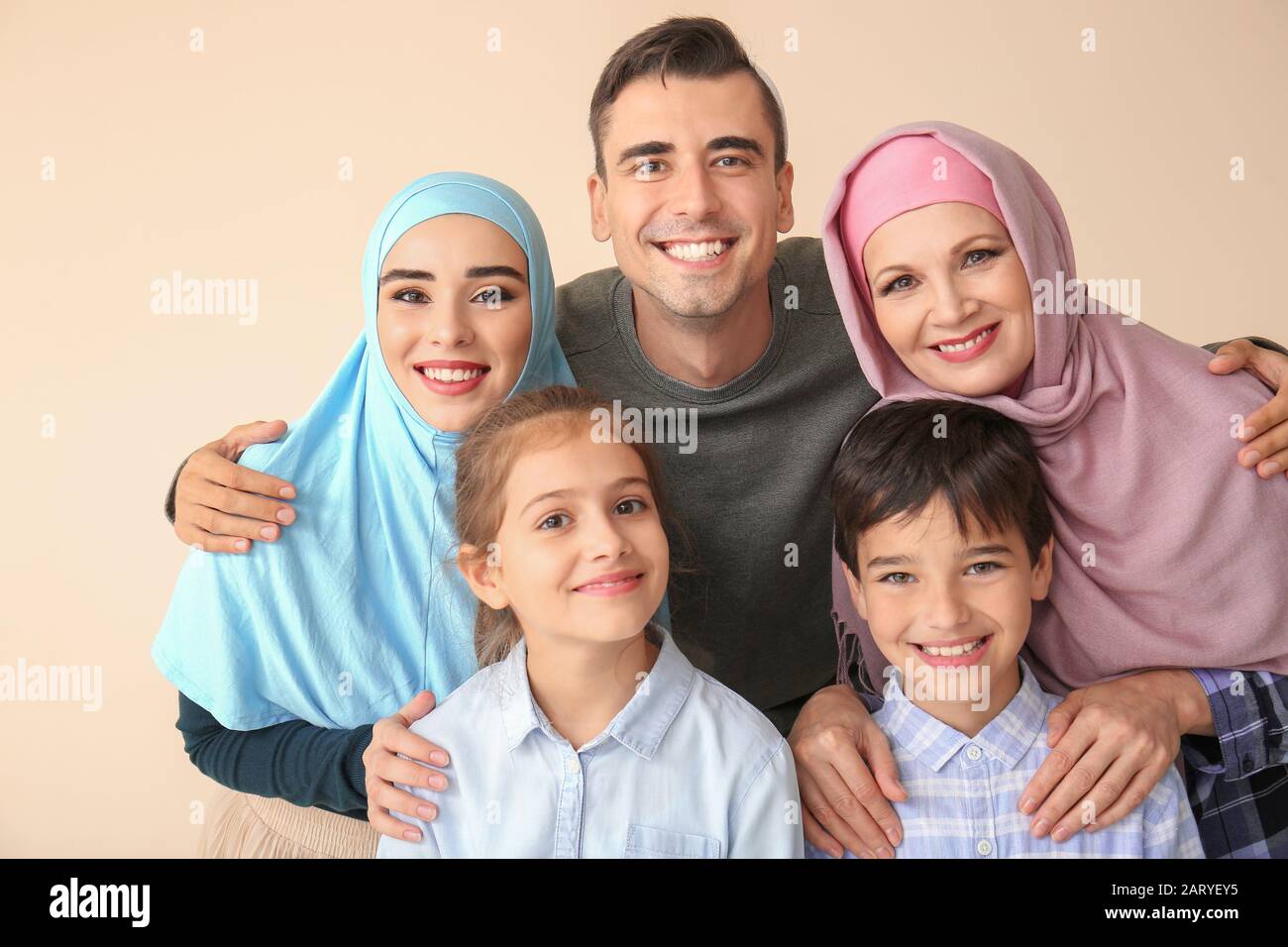 Portrait of Muslim family on light background Stock Photo - Alamy