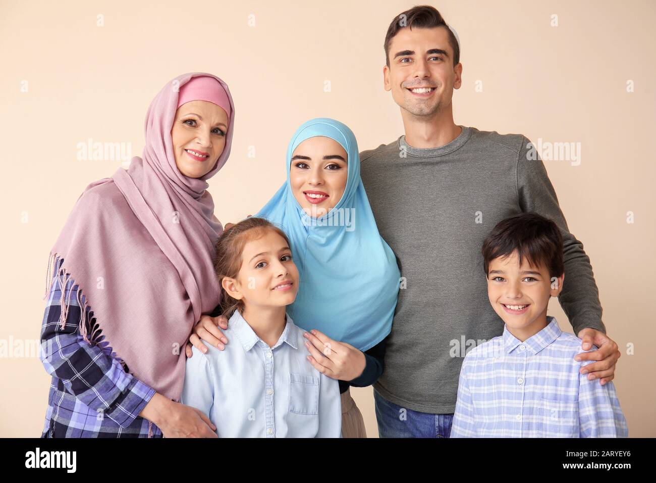 Portrait of Muslim family on light background Stock Photo - Alamy