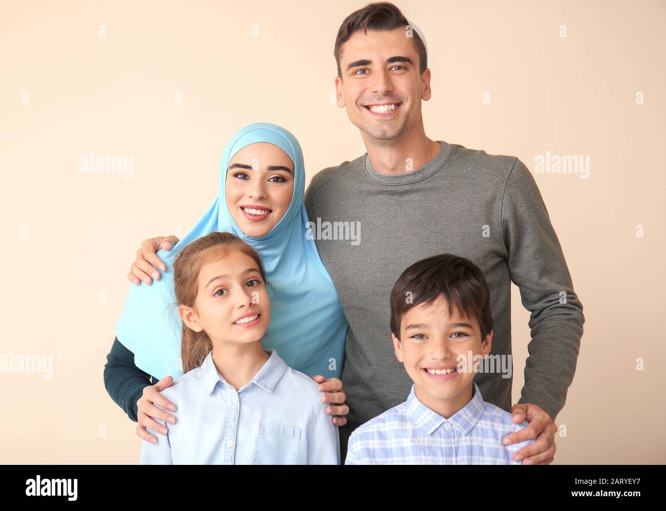 Portrait of Muslim family on light background Stock Photo - Alamy