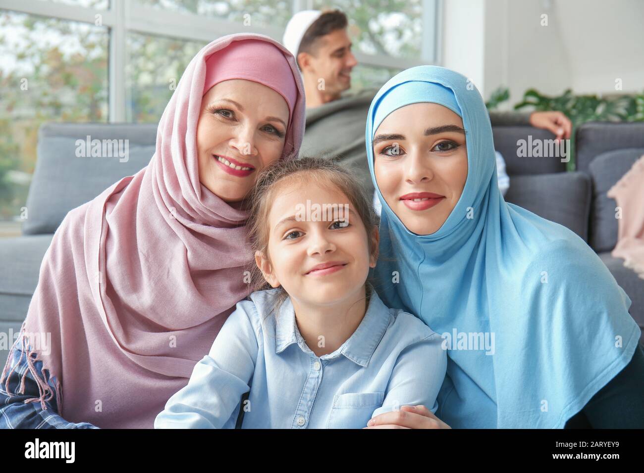 Portrait of happy Muslim family at home Stock Photo - Alamy