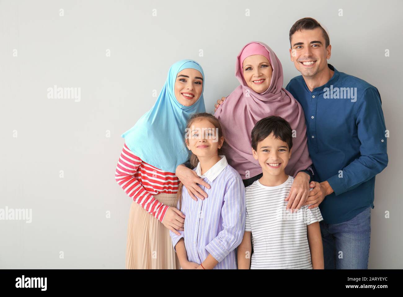 Portrait of Muslim family on light background Stock Photo - Alamy
