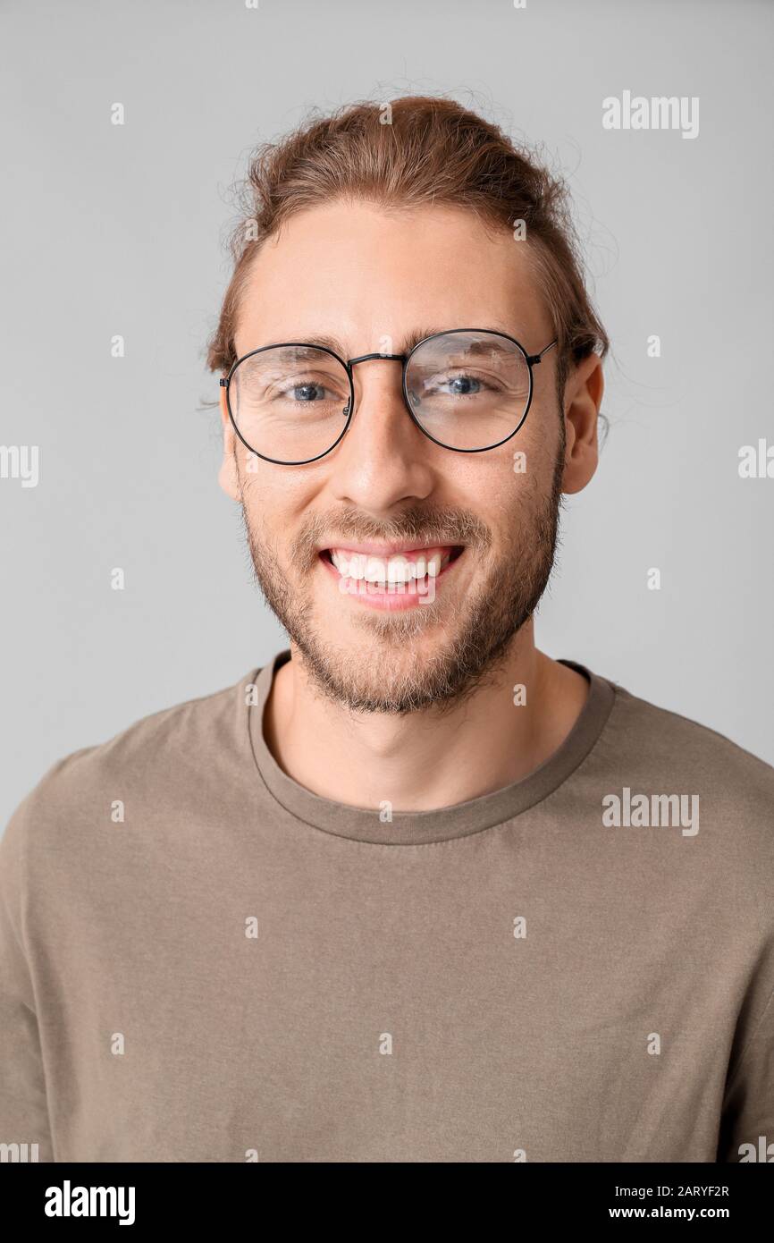 Portrait of handsome man on grey background Stock Photo - Alamy