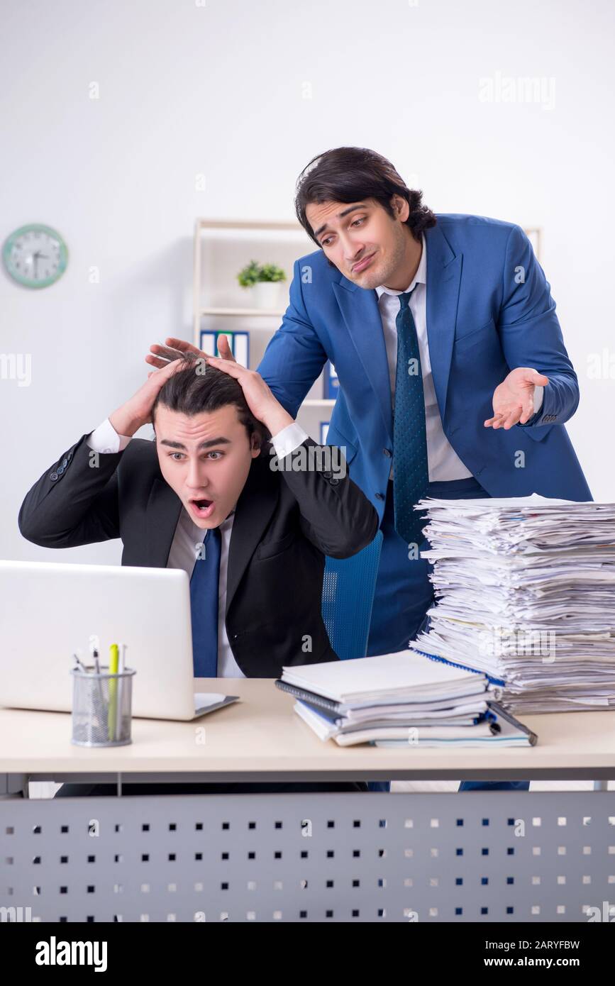 The two male colleagues unhappy with excessive work Stock Photo - Alamy