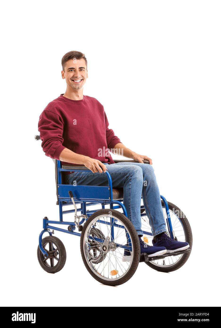Handicapped young man in wheelchair on white background Stock Photo - Alamy