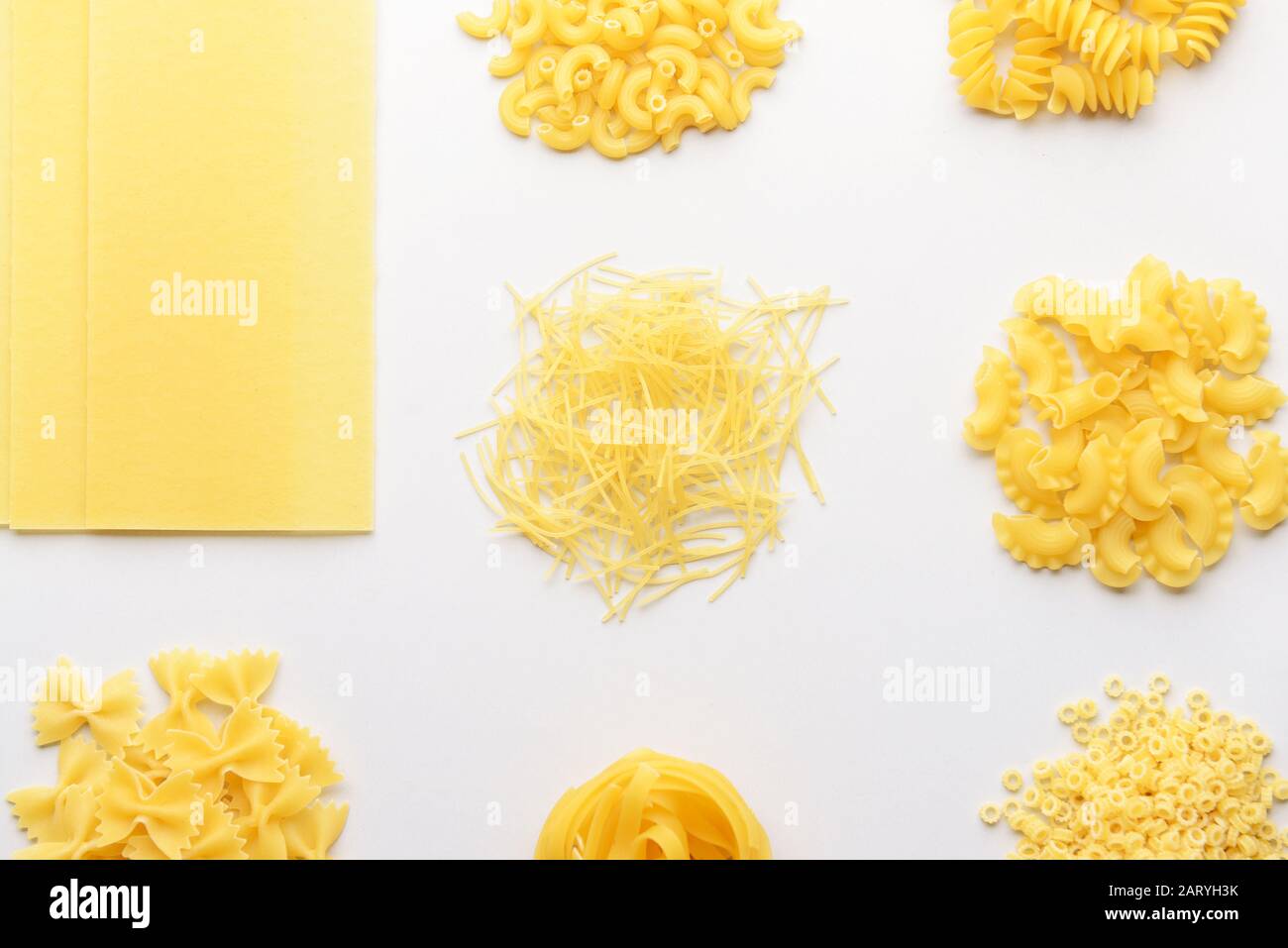 Different uncooked pasta on white background Stock Photo - Alamy