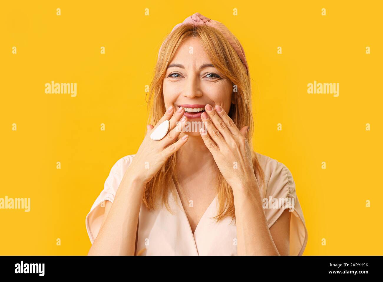 Flattered mature woman on color background Stock Photo - Alamy