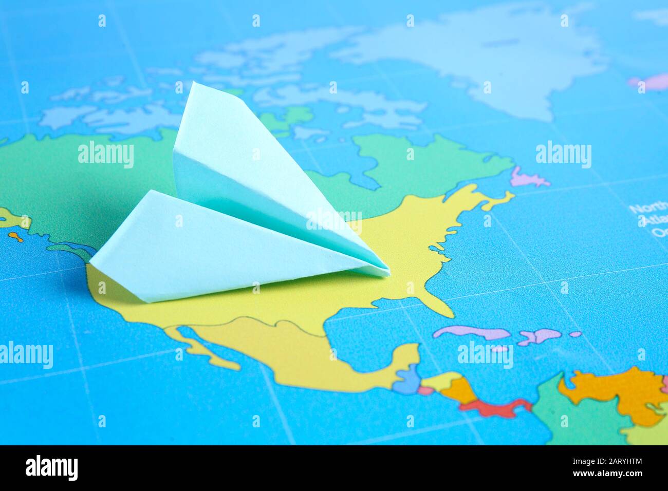Origami airplane on world map Stock Photo - Alamy