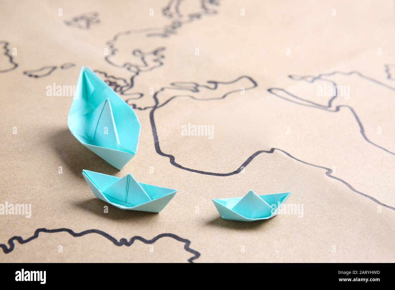 Origami boats on world map Stock Photo - Alamy