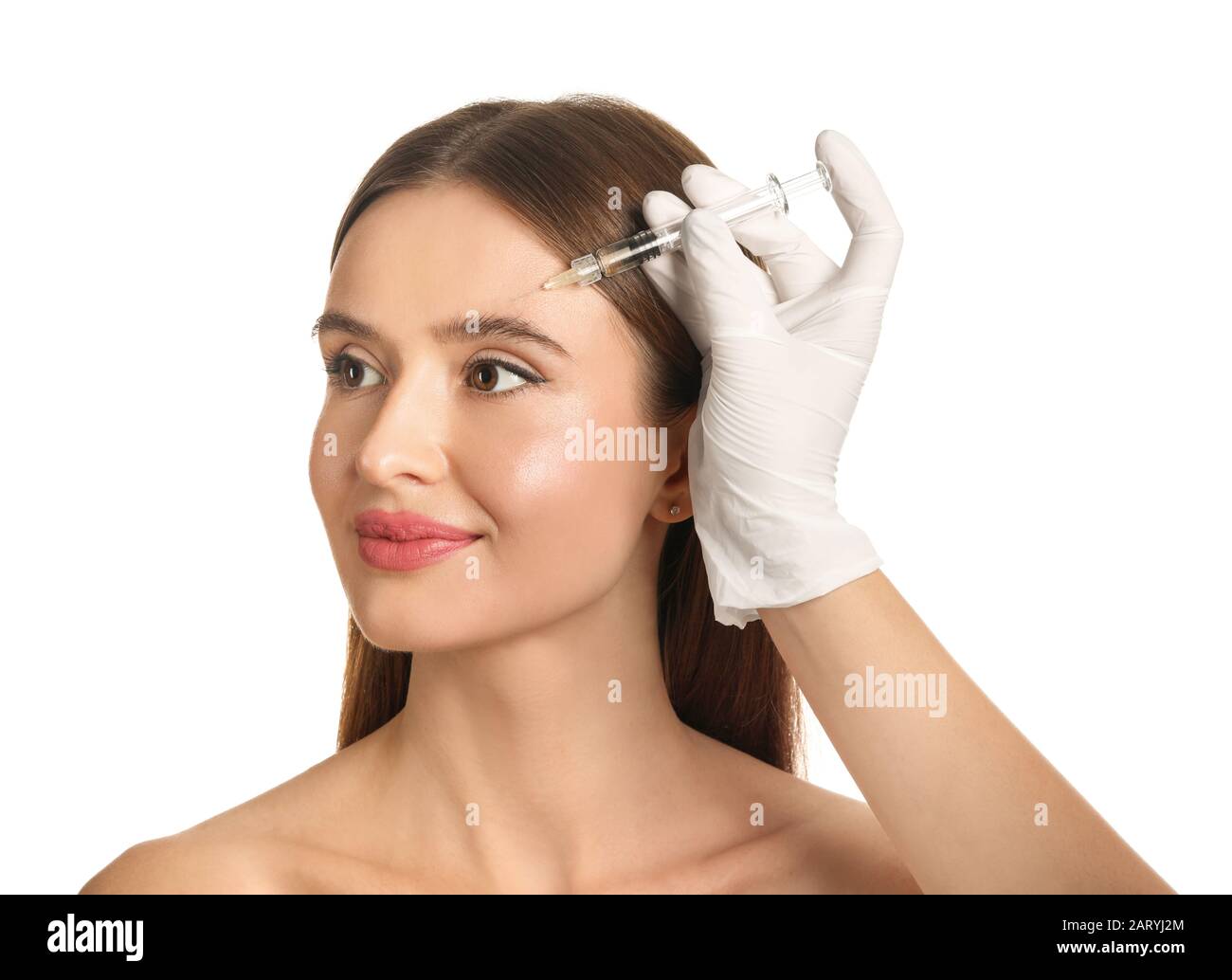 Young woman receiving filler injection against white background Stock ...