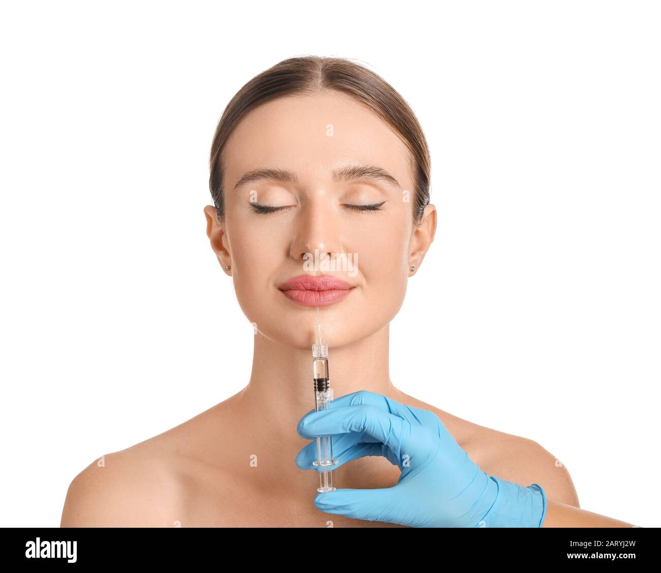 Young woman receiving filler injection against white background Stock ...