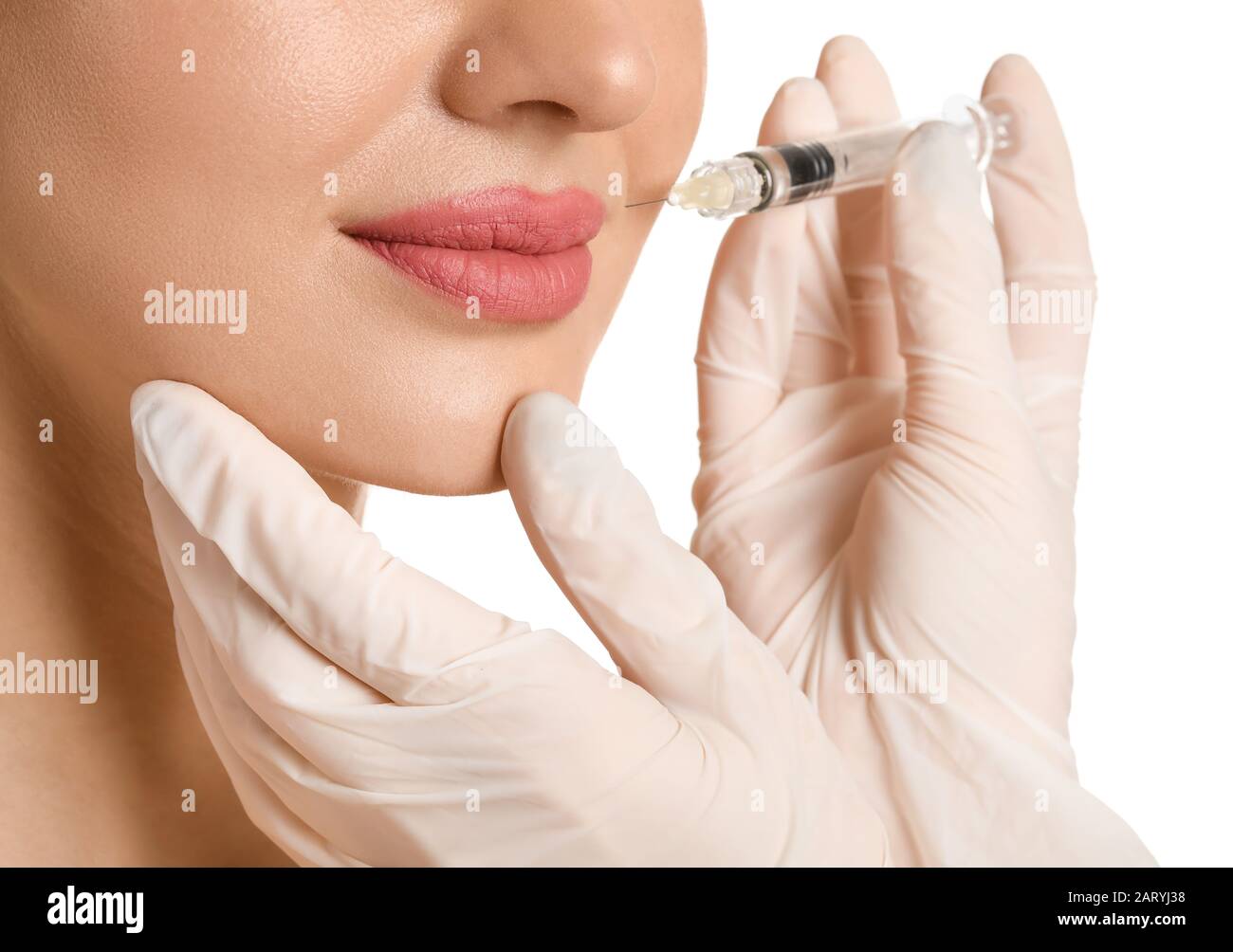 Young woman receiving filler injection against white background ...