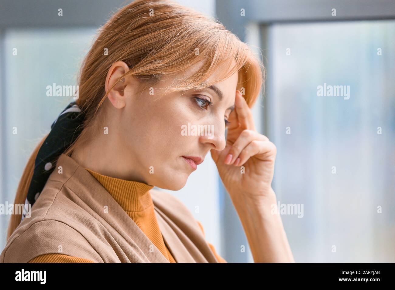 Portrait of depressed woman near window Stock Photo - Alamy