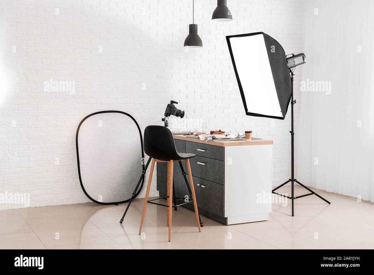 Interior of modern photo studio with professional equipment and food on ...