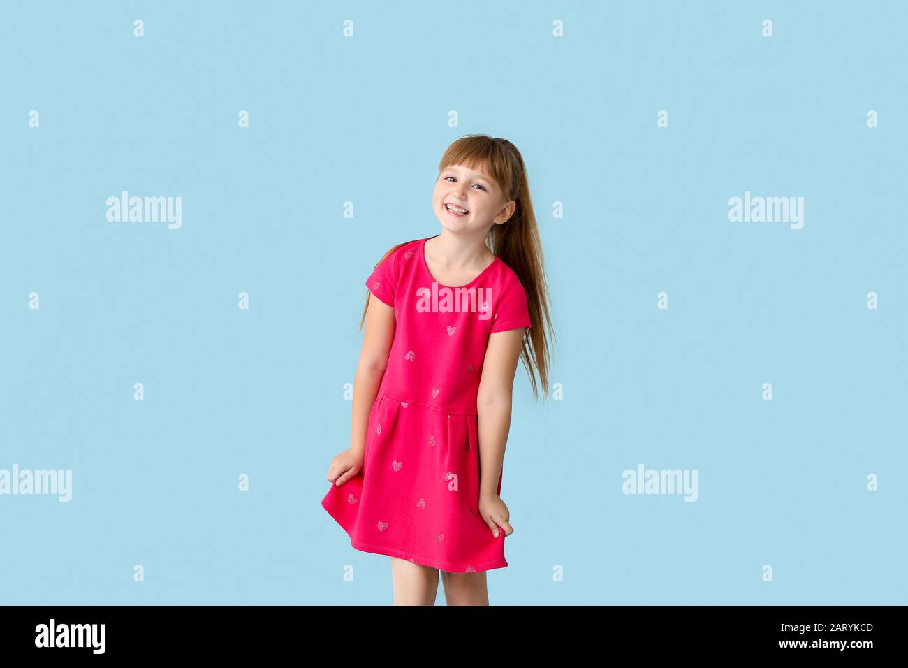 Cute little girl on color background Stock Photo - Alamy
