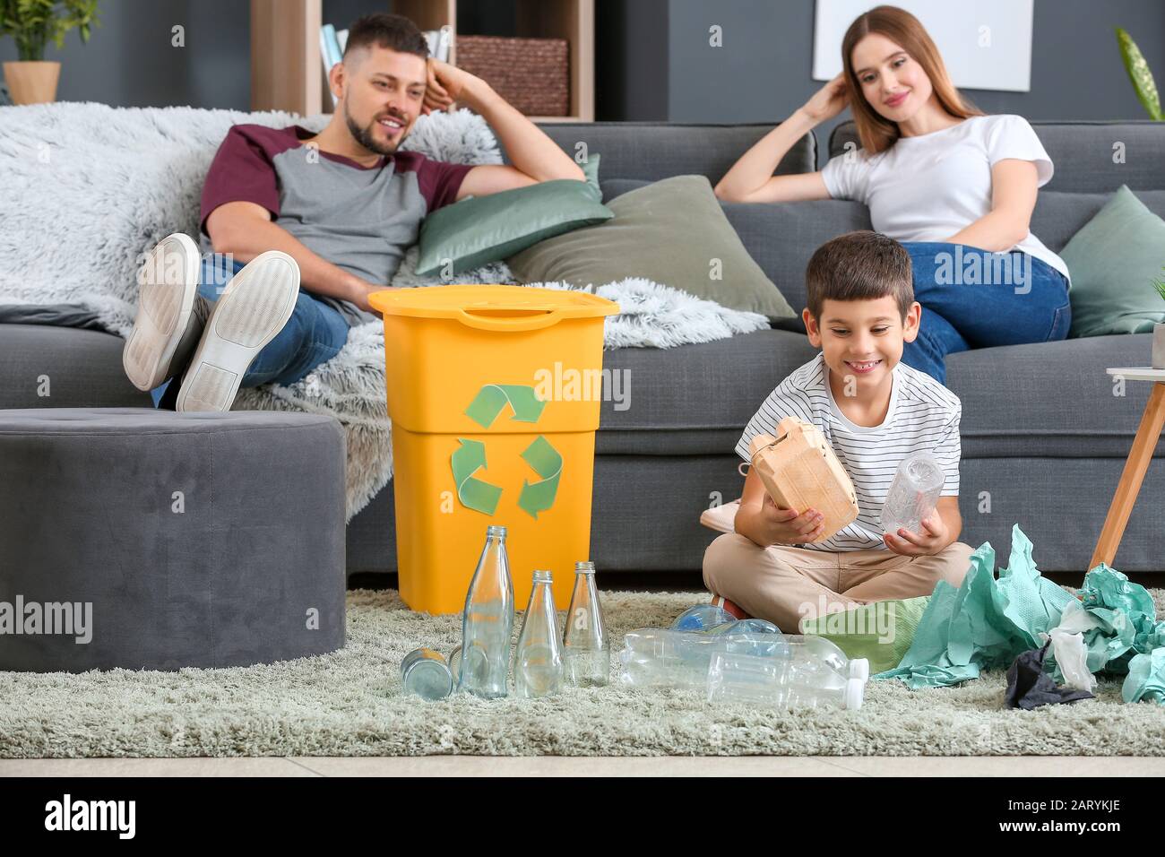 Family with garbage and container at home. Concept of recycling Stock ...