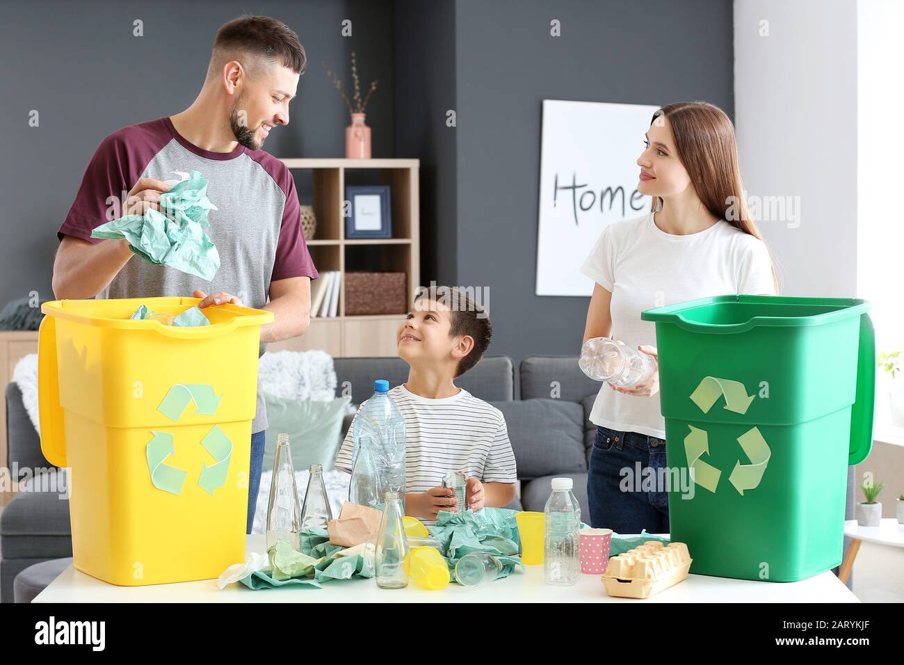 Family sorting garbage at home. Concept of recycling Stock Photo - Alamy