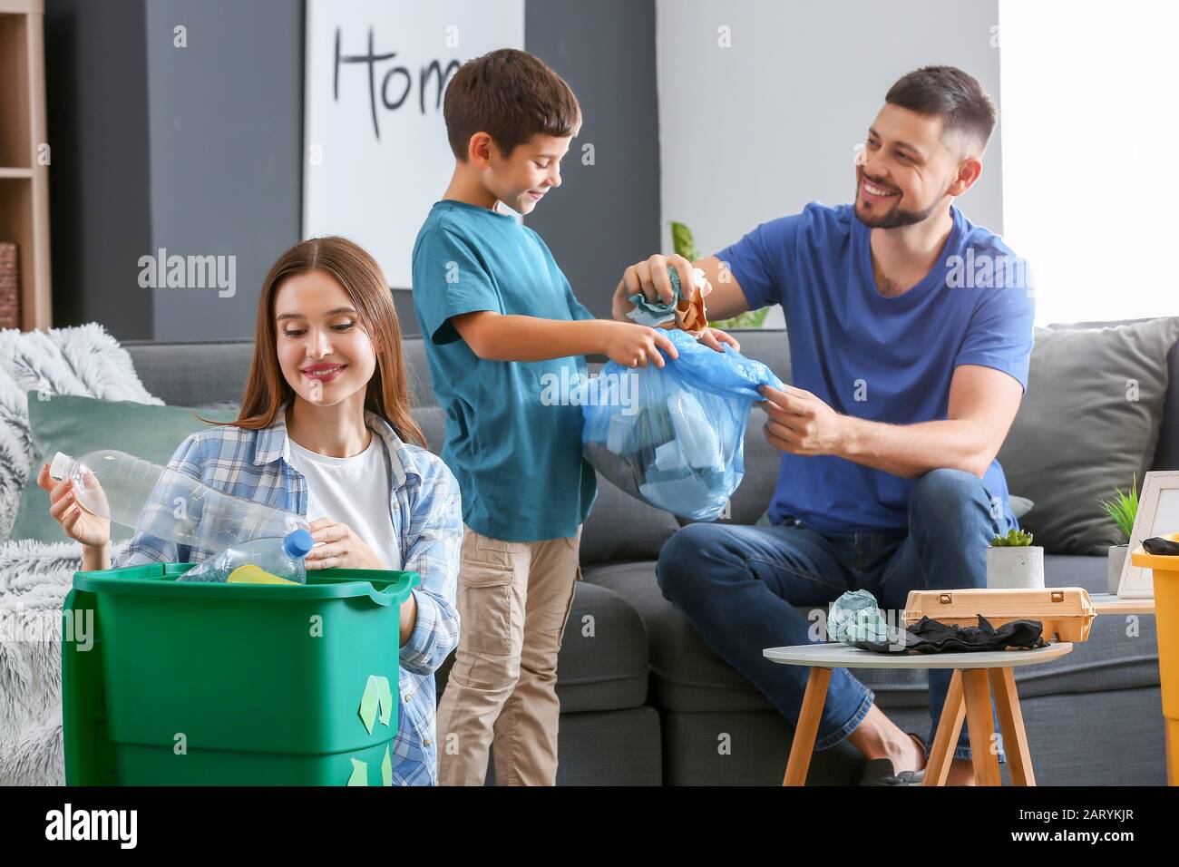 Family sorting garbage at home. Concept of recycling Stock Photo - Alamy