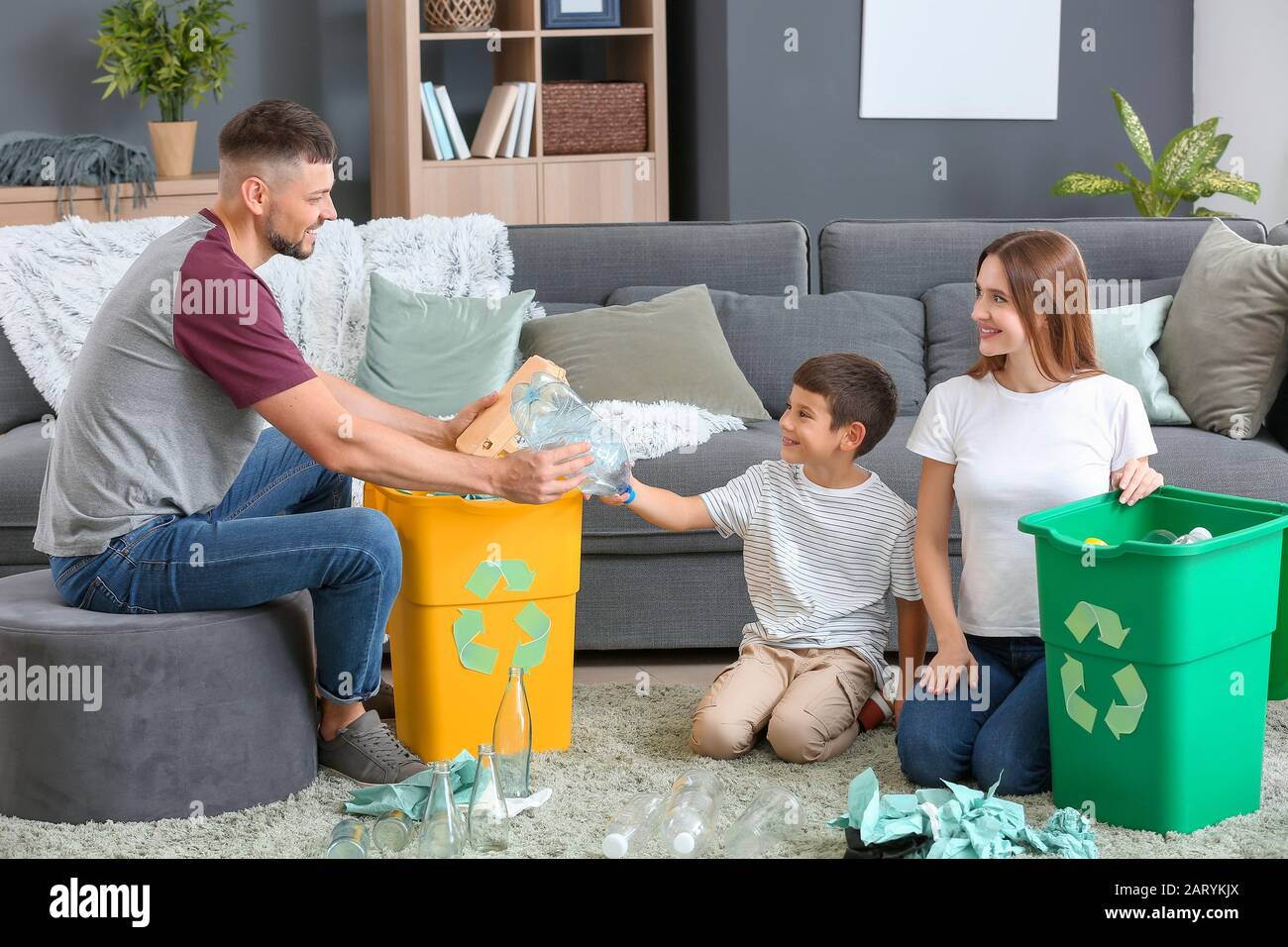 Family sorting garbage at home. Concept of recycling Stock Photo - Alamy