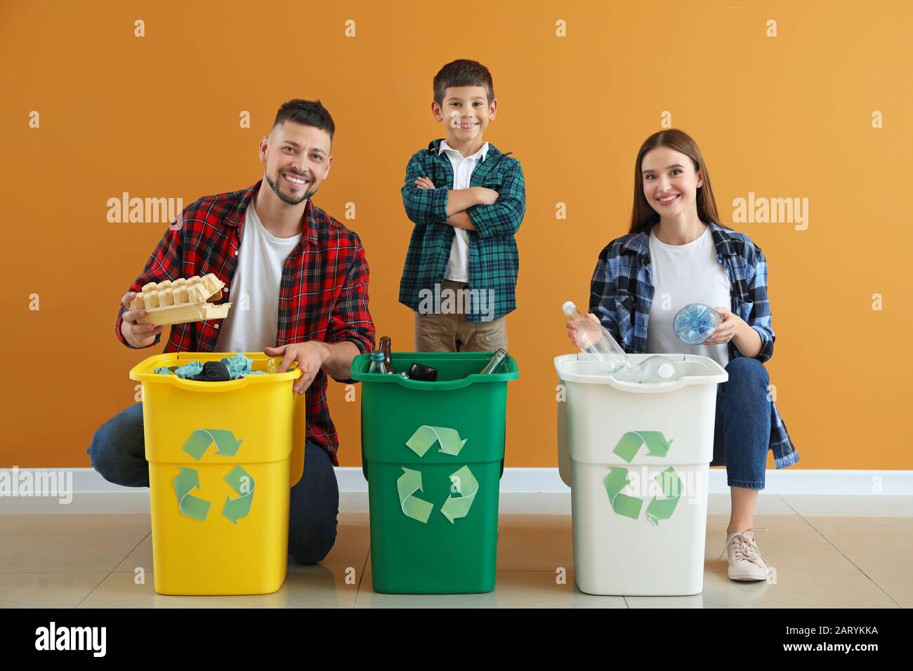Family with containers for garbage on color background. Concept of ...
