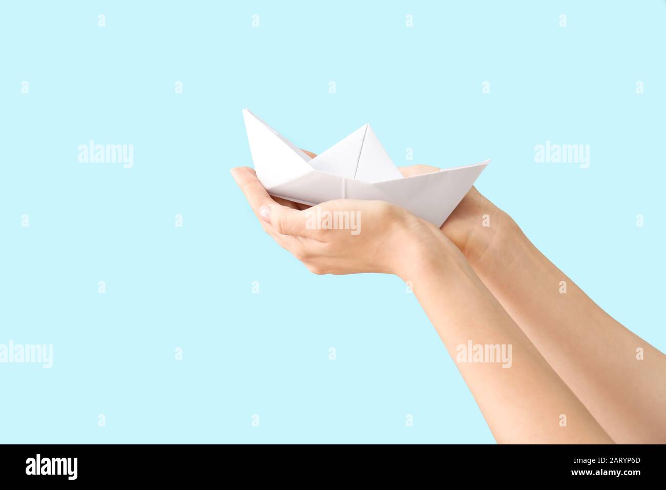 Female hands origami boat hi-res stock photography and images - Alamy