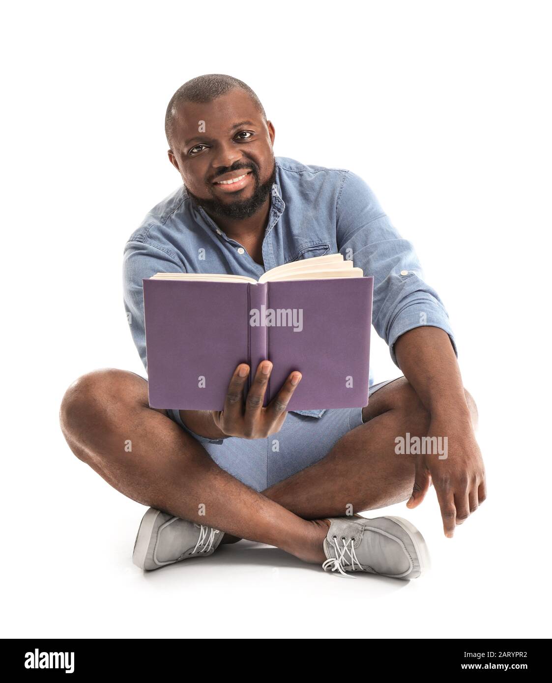 African-American man reading book on white background Stock Photo - Alamy