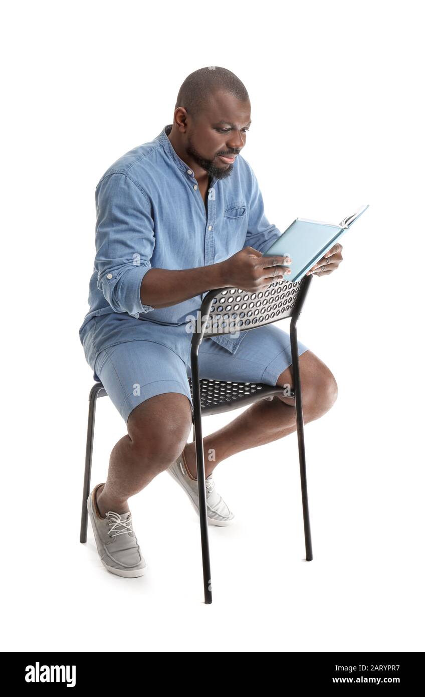 African-American man reading book on white background Stock Photo - Alamy