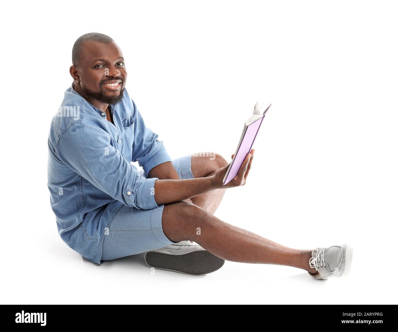 African-American man reading book on white background Stock Photo - Alamy