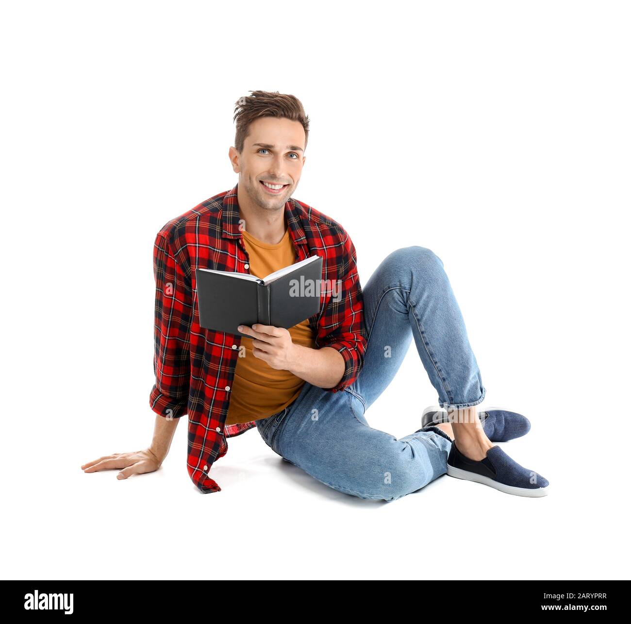 Handsome young man reading book on white background Stock Photo - Alamy