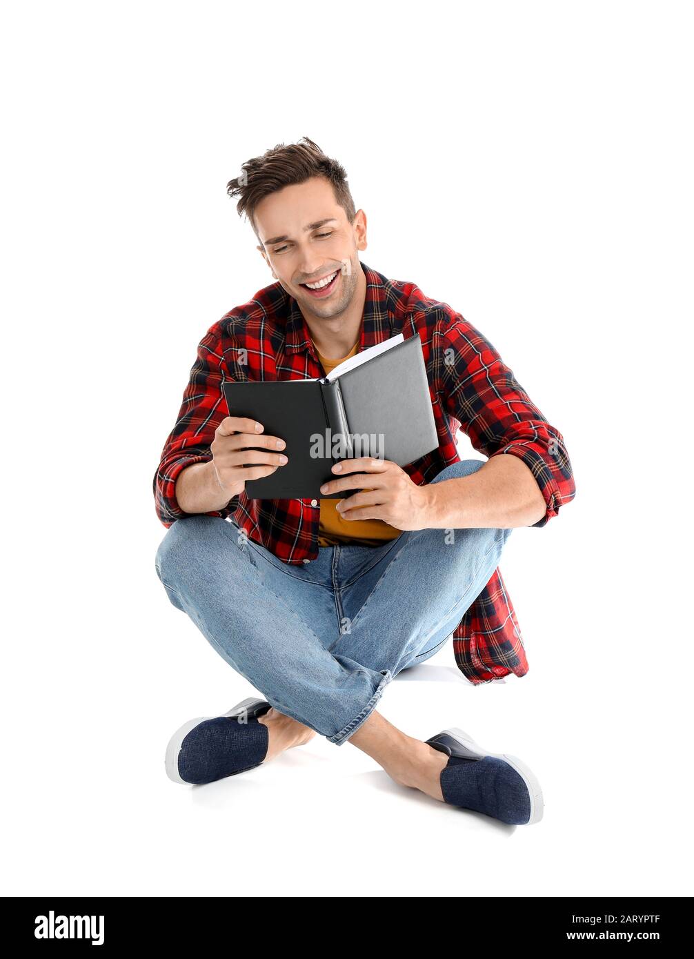 Handsome young man reading book on white background Stock Photo - Alamy